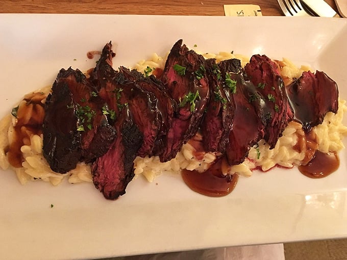 Perfectly sliced hanger steak over risotto—proof that sometimes the best things in life come arranged in neat rows atop creamy carbs.