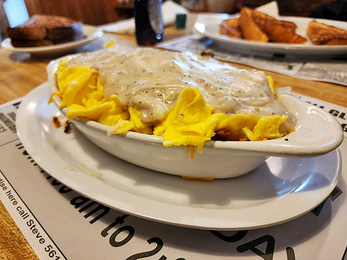 A beautiful marriage of cheese, eggs and potatoes smothered in country gravy. This isn't just breakfast – it's emotional support in bowl form.