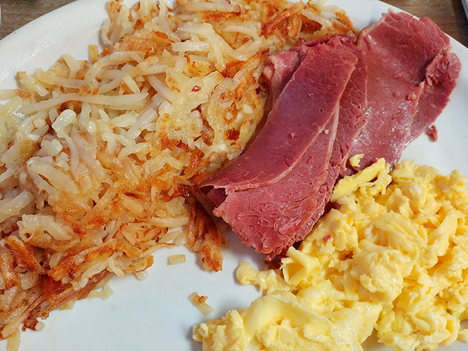 Breakfast nirvana: crispy hash browns, tender corned beef, and fluffy scrambled eggs—the holy trinity of morning meals that'll fuel you through anything Detroit throws your way.