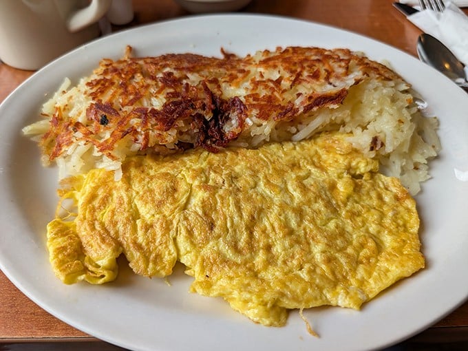 The perfect marriage of golden hash browns and fluffy eggs—a breakfast duet that performs on your palate like Martin and Lewis in their prime.
