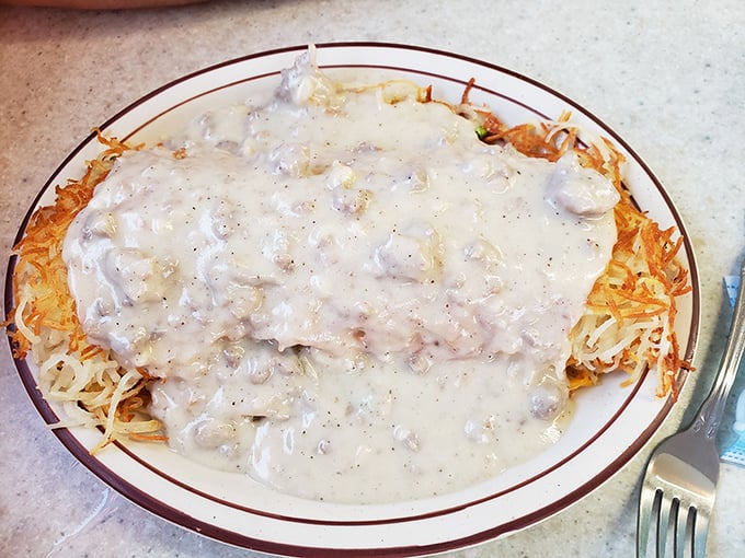 Hashbrowns smothered in country gravy—where crispy potato meets creamy, peppery heaven in a marriage that would make cardiologists nervous.