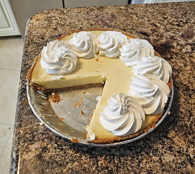 Key lime pie so authentic it should come with its own Florida citizenship papers. That whipped cream border isn't just decoration—it's destiny.