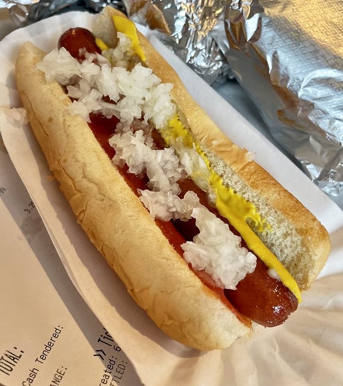 Hot dog royalty! Perfectly nestled in a pillowy bun with mustard and onions—proof that simplicity, when done right, is the ultimate sophistication.