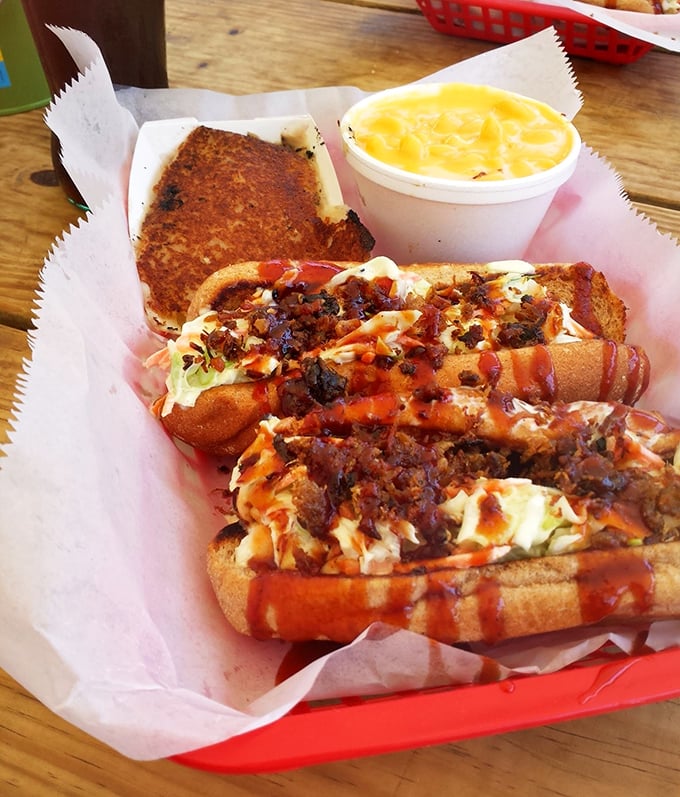 Hot dogs elevated to art form – topped with slaw, sauce, and crackling that provides the kind of crunch worth writing home about.