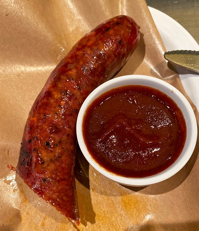 The hot link snaps with attitude when you bite into it, releasing juices that demand to be sopped up with that sauce—a perfect marriage of spice and smoke.