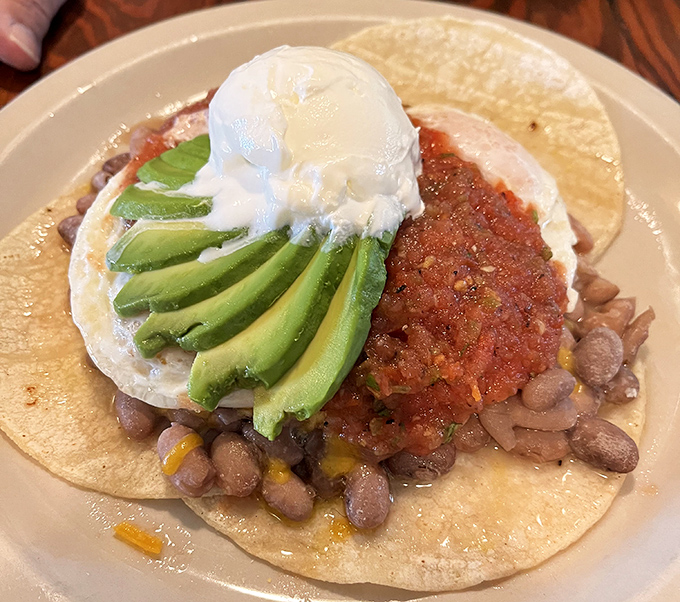 Huevos rancheros that would make your abuela proud. That poached egg perched atop beans, salsa, and avocado is begging to release its golden treasure.