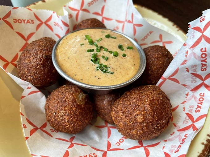 Golden-brown hush puppies that could make a Southerner homesick, served with a dipping sauce worth bottling and hoarding.