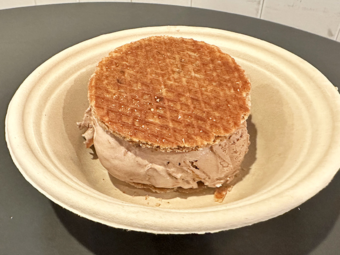 Not just any ice cream sandwich—this is architecture in dessert form, with golden waffle cookies embracing ice cream like old friends reuniting.