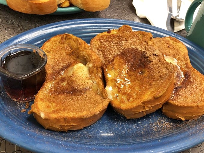 This isn't just French toast—it's a cinnamon-dusted island of crispy-edged, custardy-centered bliss waiting for its maple syrup waterfall.