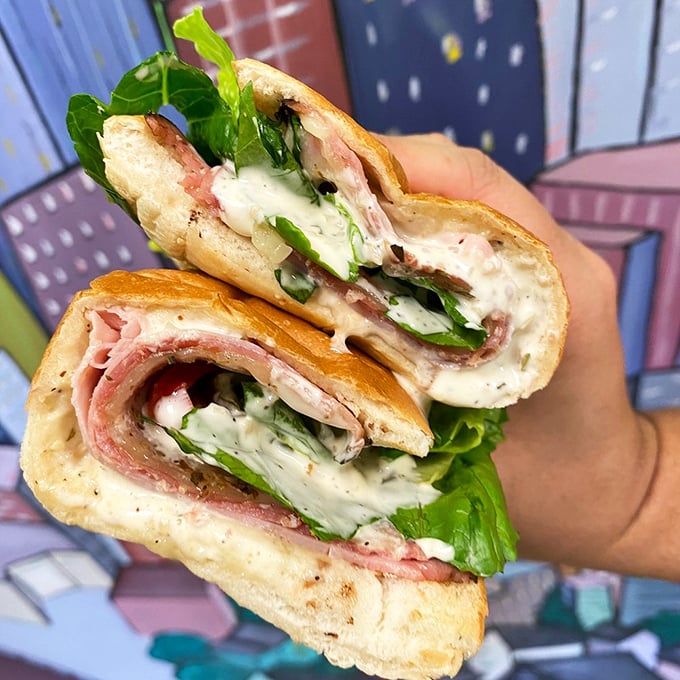 This Italian sub cross-section reveals the architectural genius behind Mickey's creations – perfect meat-to-cheese ratios and fresh greens creating a harmonious flavor symphony.