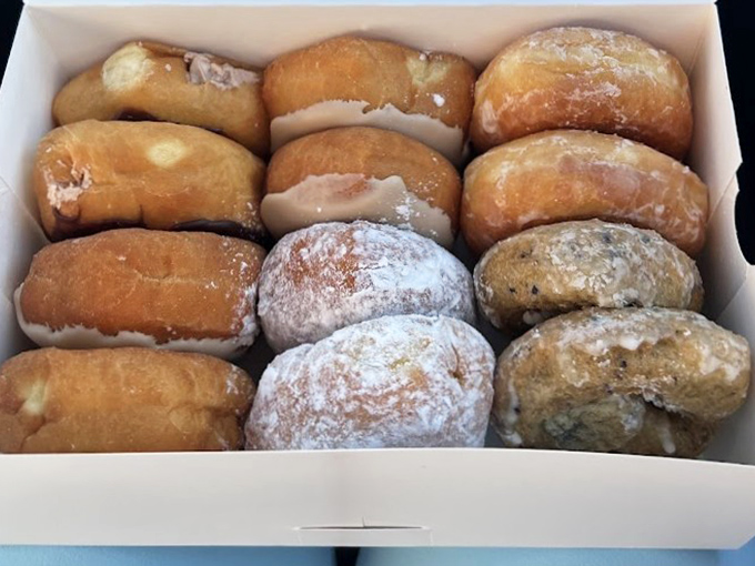 A dozen reasons to smile packed neatly in a box—from classic glazed to powdered sugar that'll inevitably end up on your shirt. Worth it.