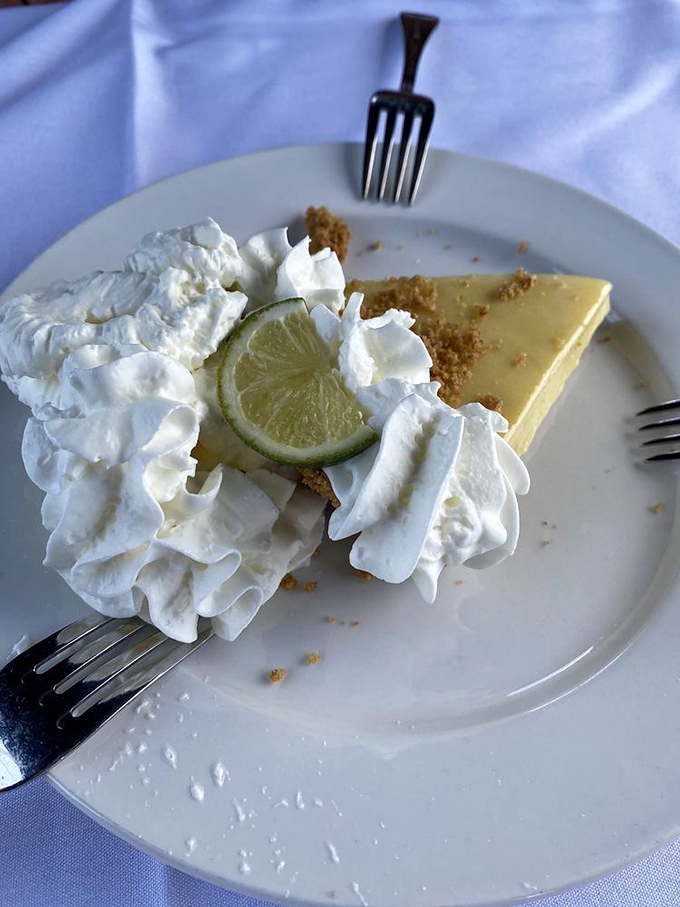 The key lime pie arrives with clouds of whipped cream—a perfect balance of sweet and tart that captures Florida sunshine in every bite.