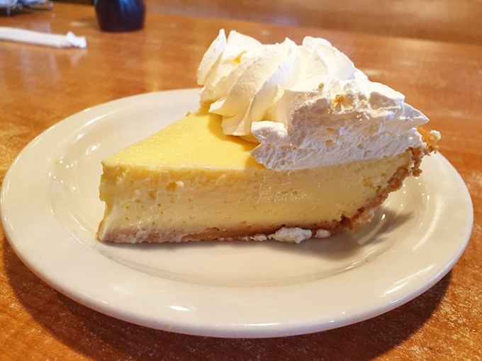 The pale yellow hue doesn't lie—this is authentic key lime pie, not the neon green imposters. That whipped cream crown deserves a royal salute.