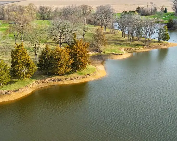 Lake Storey Park offers the kind of serene water views that usually require a second mortgage or a timeshare presentation, but here they're just part of daily life.