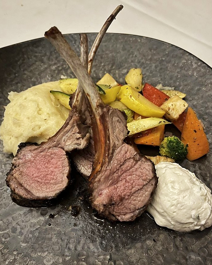 These lamb chops aren't just cooked—they're respected. Perfectly pink, artfully presented, and making those vegetables feel like they've been invited to the cool table.