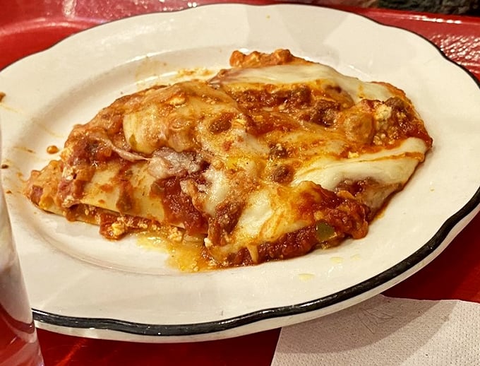 Lasagna layers built like edible architecture, proving Italian comfort food transcends all geographical boundaries and expectations.