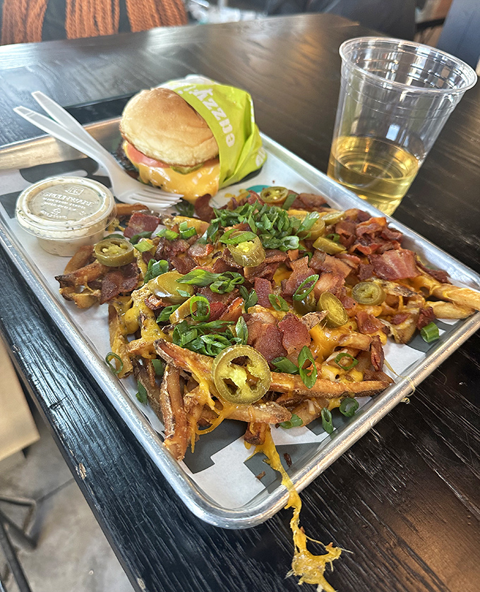 Loaded fries that could be a meal themselves—bacon, cheese, jalapeños, and green onions creating a flavor party worth the extra napkins.
