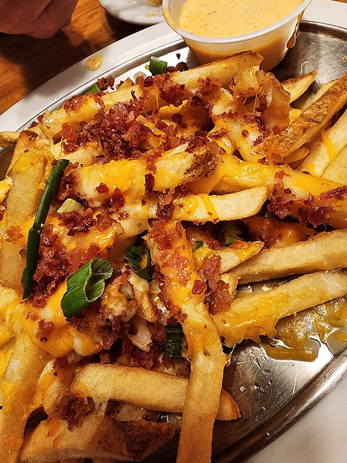 These loaded fries aren't just a side – they're a main event, with bacon and cheese creating the kind of indulgence that makes your cardiologist wince and your taste buds applaud.