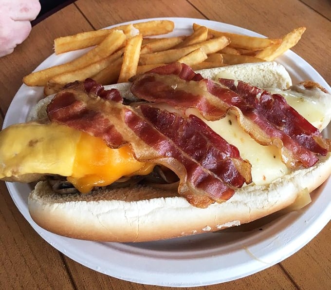 Not just any hot dog – this is architectural achievement in sandwich form. Bacon, cheese, and toppings stacked with the ambition of a Florida condo developer.