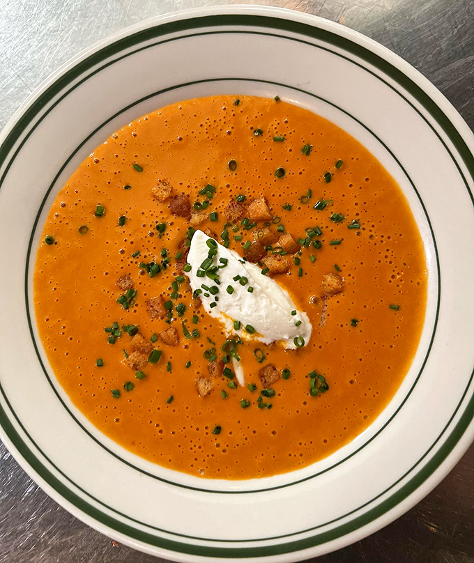 Manhattan clam chowder gets the star treatment with a dollop of cream and fresh herbs—tomato-based brilliance that would make even die-hard New Englanders reconsider their loyalties.
