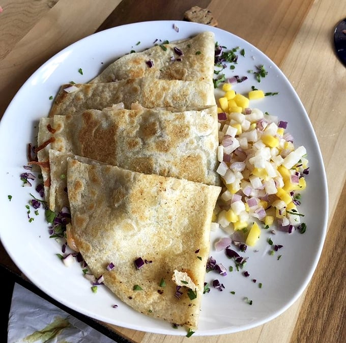 Golden-crisp quesadillas paired with a vibrant mango salsa—proof that sometimes the simplest combinations create the most memorable symphonies of flavor.