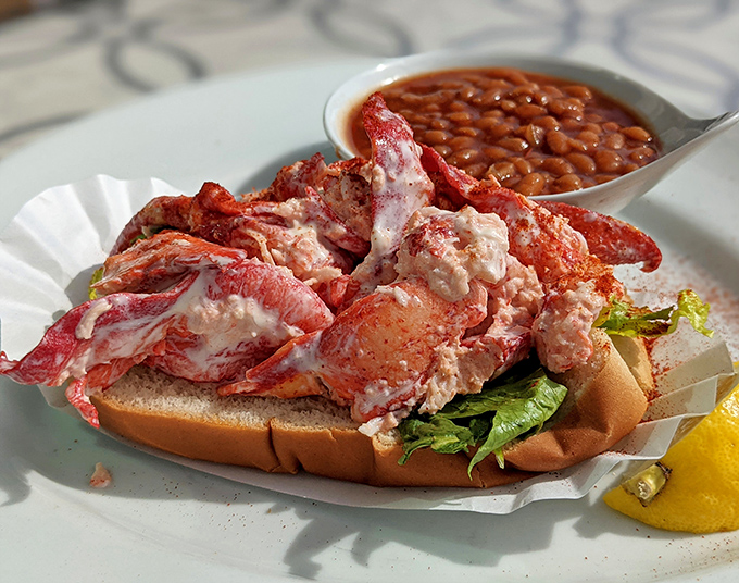 Not all heroes wear capes, but this lobster roll—overflowing with sweet meat and served with baked beans—definitely deserves a medal.