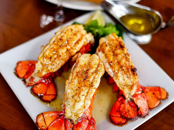 Lobster tails that look like they're auditioning for a seafood calendar – perfectly split, seasoned, and ready for their butter bath.