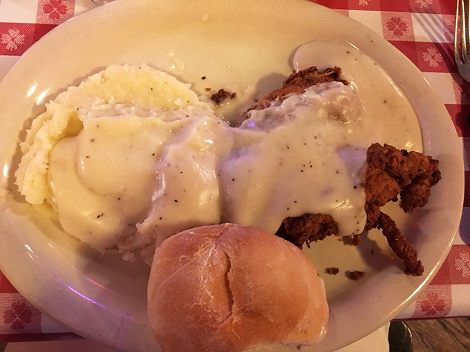 Chicken fried steak swimming in peppery gravy alongside mashed potatoes so creamy they make clouds seem crunchy by comparison.