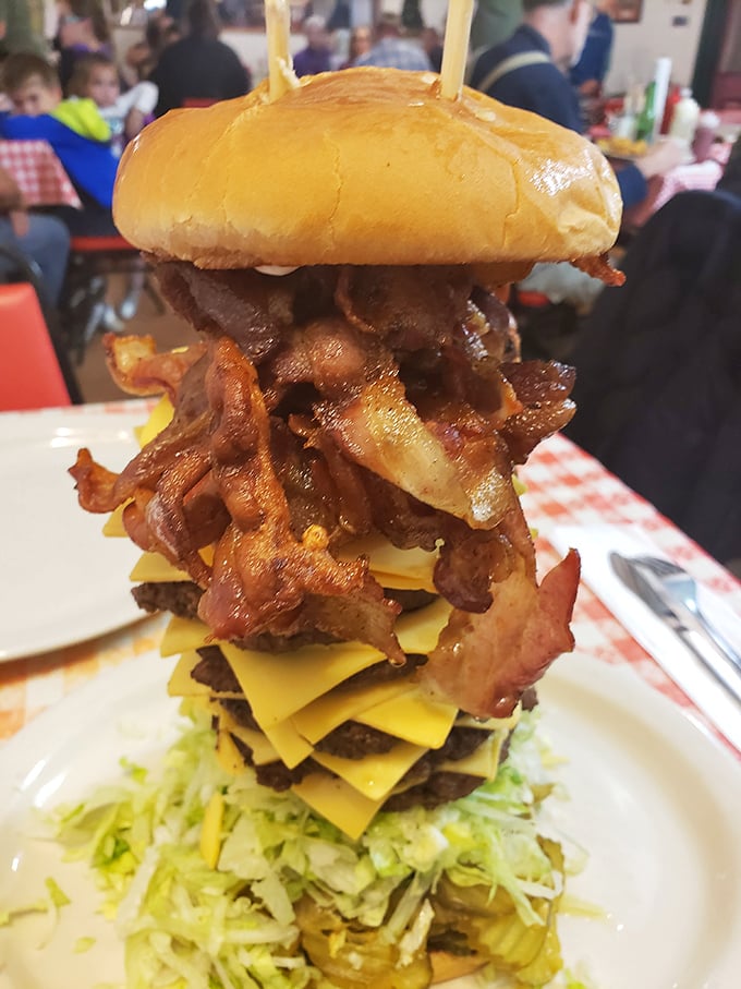 The tower of beef, bacon, and cheese isn't just a burger—it's an architectural marvel that requires both strategy and commitment.