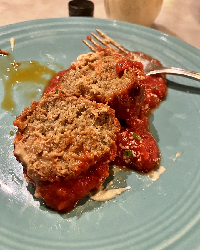 These meatballs don't just sit in sauce—they reign supreme on a throne of vibrant tomato, crowned with melty cheese and fresh herbs.