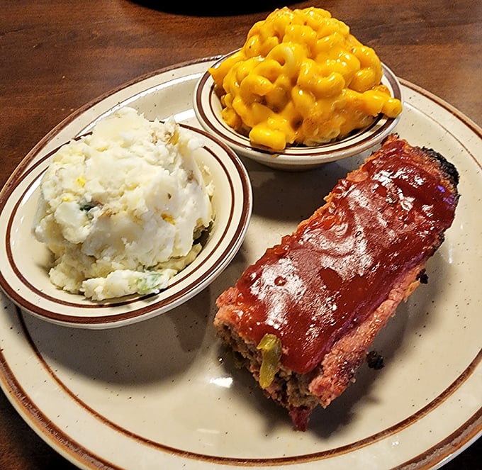 Meatloaf, mashed potatoes, and mac and cheese—the holy trinity of comfort food executed with a reverence that would make your grandmother both proud and slightly jealous.