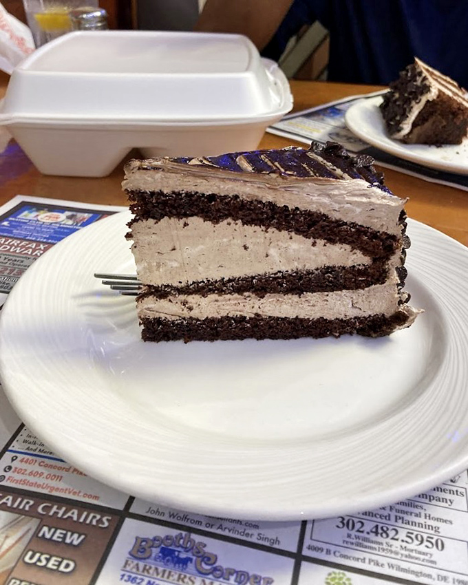 Layer upon layer of chocolate cake and creamy frosting—a dessert skyscraper that makes you wonder if you should take a picture or just dive in face-first.