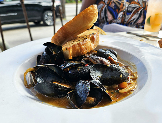 These mussels aren't just swimming in broth—they're luxuriating in it, with crusty bread standing by for the inevitable (and necessary) sopping up.