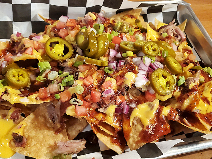 BBQ nachos that defy gravity and good manners. The jalapeños aren't just garnish—they're little green flavor grenades waiting to detonate on your taste buds.