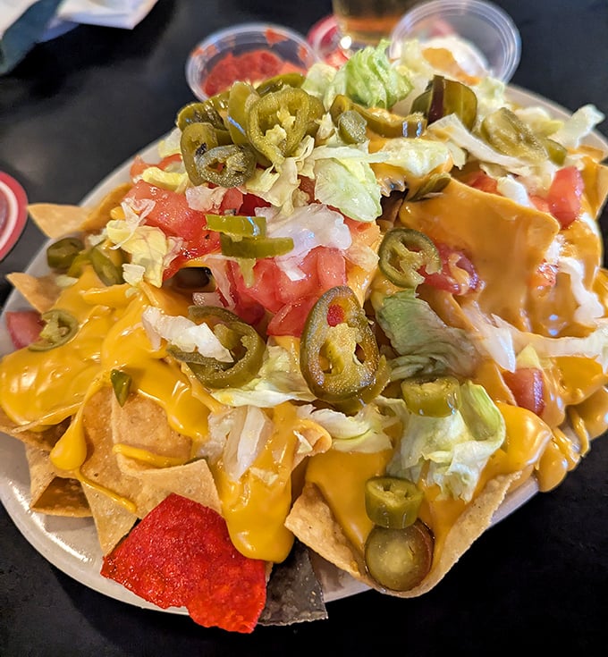 These nachos aren't just a appetizer—they're an architectural marvel of cheese, jalapeños, and toppings that requires strategic planning to conquer.