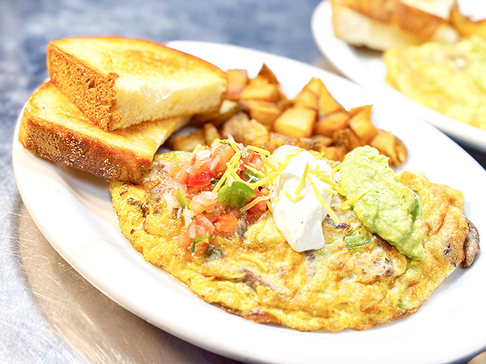 An omelet should be a perfect marriage of fluff and flavor—this one looks like it just renewed its vows with a side of golden home fries.