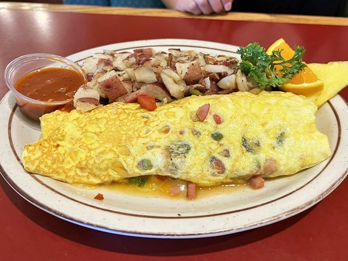 This isn't just an omelet—it's a masterpiece of morning engineering with perfectly distributed fillings and hashbrowns that demand attention.