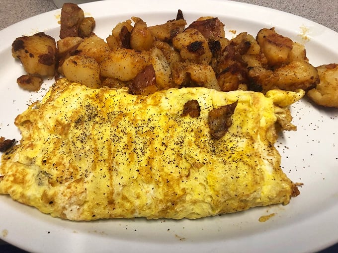 This omelet and home fries combo isn't just breakfast, it's edible therapy. The pepper specks aren't decoration; they're little flavor bombs.