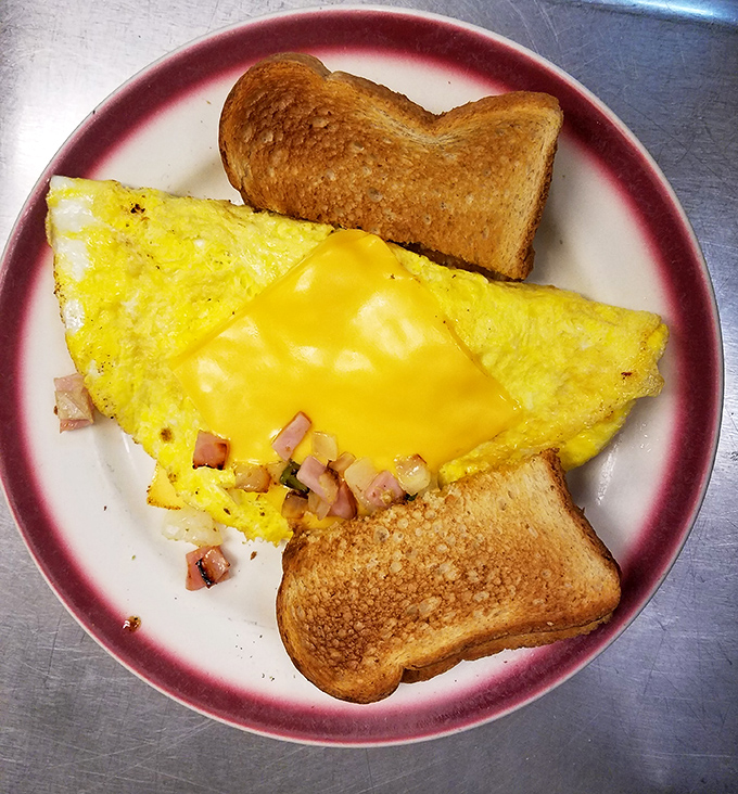Behold the perfect omelet—folded like a letter containing the good news that breakfast doesn't need to be complicated to be magnificent.
