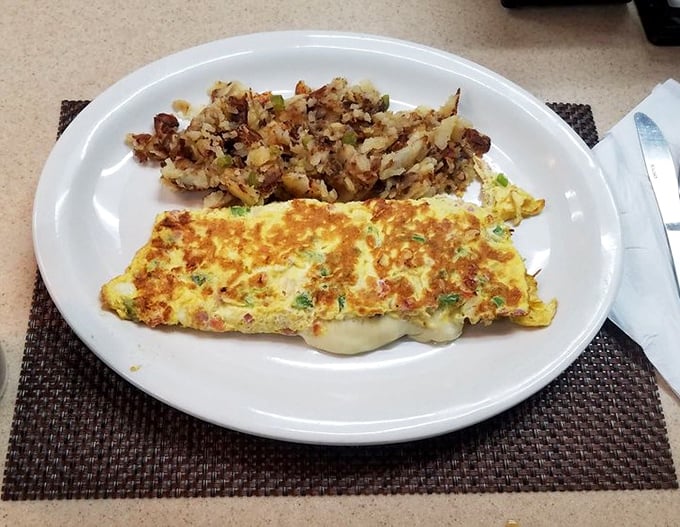 This isn't just any omelette—it's a masterclass in egg architecture with home fries that deserve their own Pennsylvania historical marker.