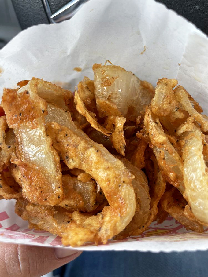 These aren't your average onion rings—they're golden halos of crispy perfection that make you wonder why anyone bothers with jewelry when these exist. 
