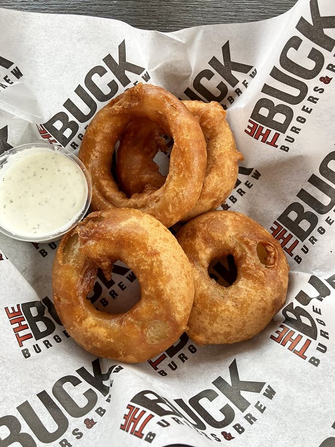 These onion rings aren't just appetizers—they're golden halos of happiness with a side of heavenly dipping sauce.