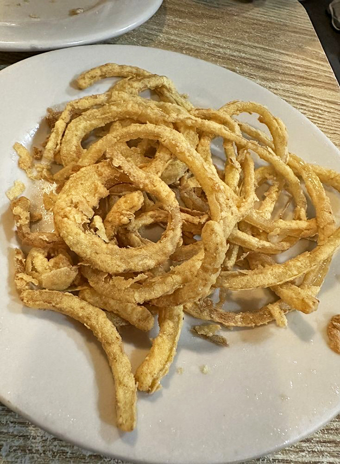 These onion rings aren't just side dishes – they're golden halos of crispiness that deserve their own fan club and commemorative t-shirt.