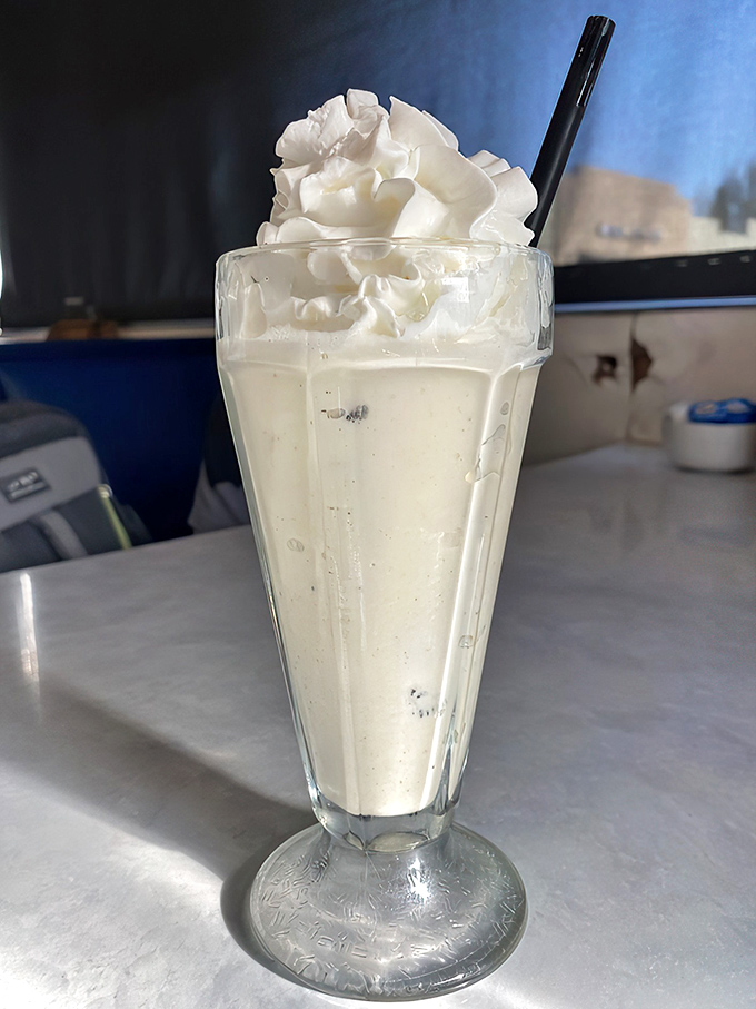 The milkshake that time forgot—thick, creamy, and topped with a mountain of whipped cream. Drinking dessert is perfectly acceptable before noon here.