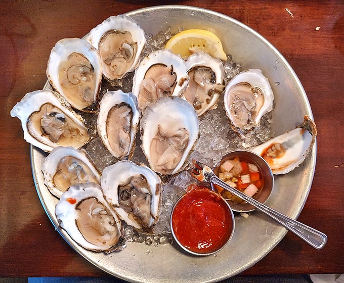 These oysters aren't just served—they're presented on a silver platter, as all proper ocean treasures should be.