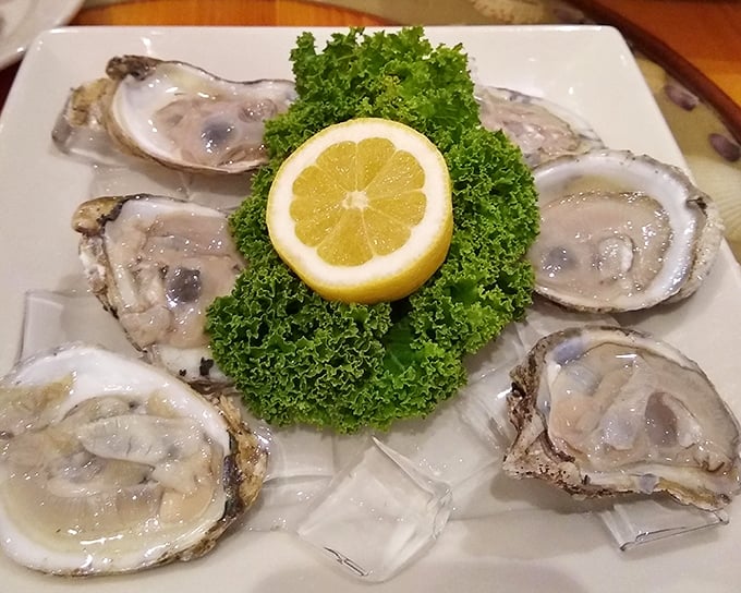 Fresh oysters on the half shell—ocean jewels arranged like a briny treasure chest, with that lemon crown adding just the right citrus punch.