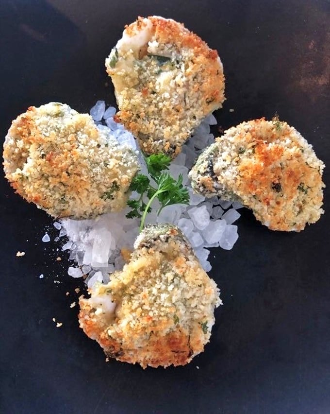 These aren't your grandmother's oysters Rockefeller, unless your grandmother was a culinary genius with a flair for perfect breadcrumb-to-brine ratios.