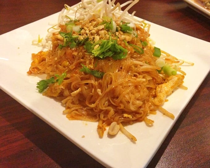Pad Thai done right is culinary poetry – these noodles, topped with crushed peanuts and fresh herbs, tell a delicious story with every bite.