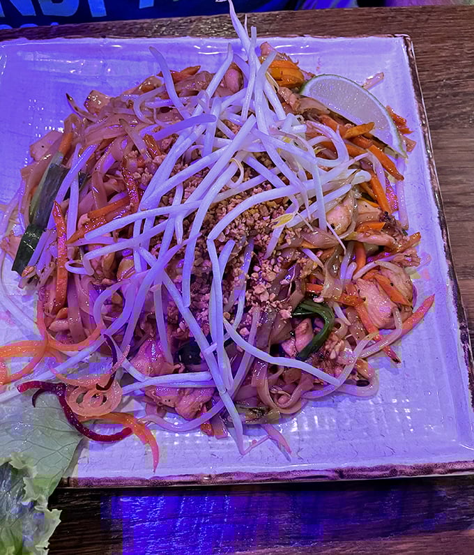 The Pad Thai arrives like a celebrity—bean sprouts standing tall like a crown, crushed peanuts waiting in the wings, and noodles ready for their close-up.