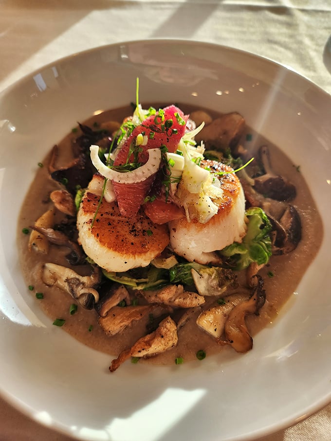 These scallops aren't just seared—they're transformed into buttery ocean jewels atop a bed of wild mushrooms and savory broth.
